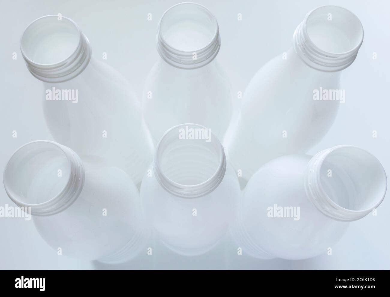Open empty white plastic milk bottles on White background Stock Photo ...