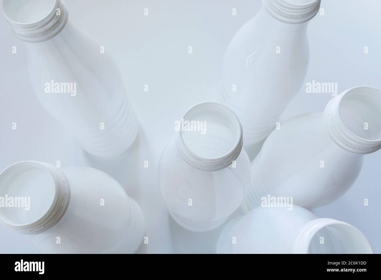 Open empty white plastic milk bottles on White background Stock Photo ...