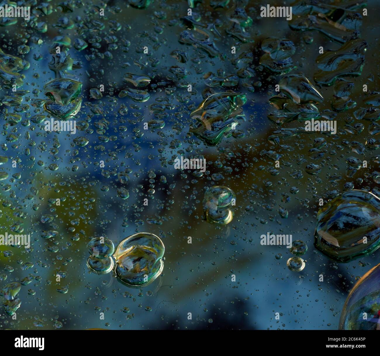 Coloured glass marbles with a background of colour infused water ...