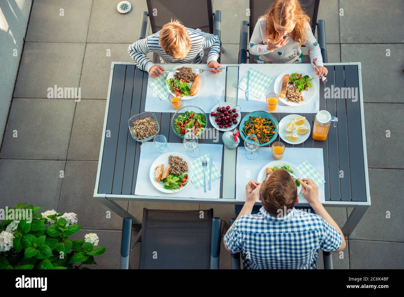 Photo view from above of happy family eating together healthy dinner on ...