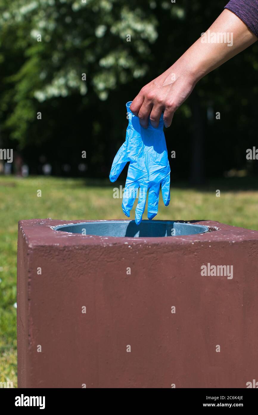 disposal of latex glove in park garbage bin Stock Photo - Alamy