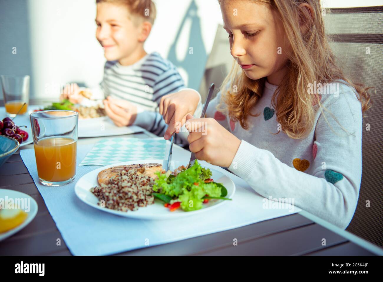 Happy family eating healthy dinner together on terrace at home Stock ...