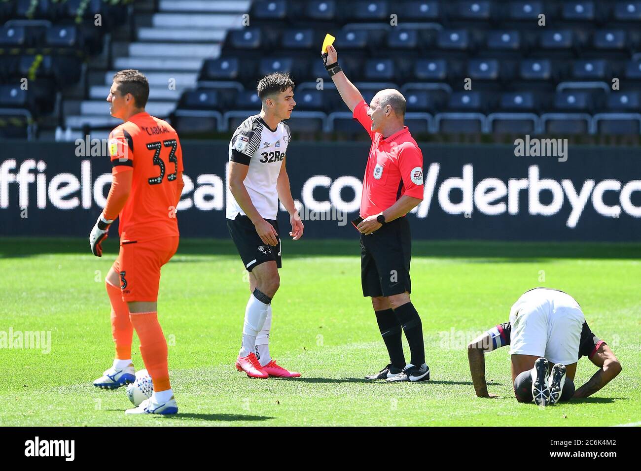 Referee Scott Duncan shows a yellow card to Tom Lawrence (10) of Derby ...