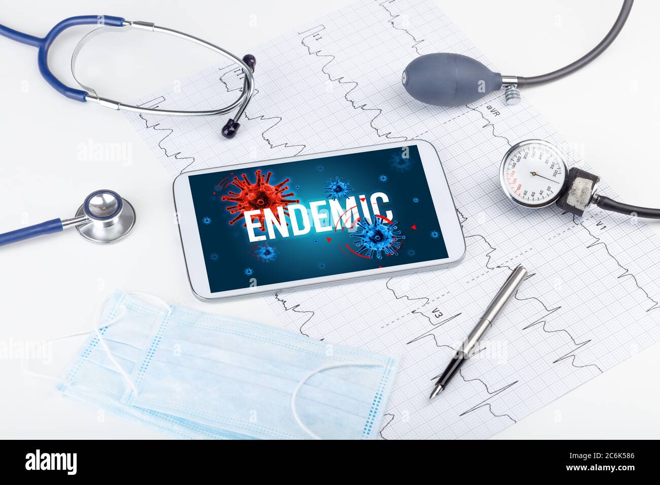 Tablet pc and doctor tools on white surface with ENDEMIC inscription ...