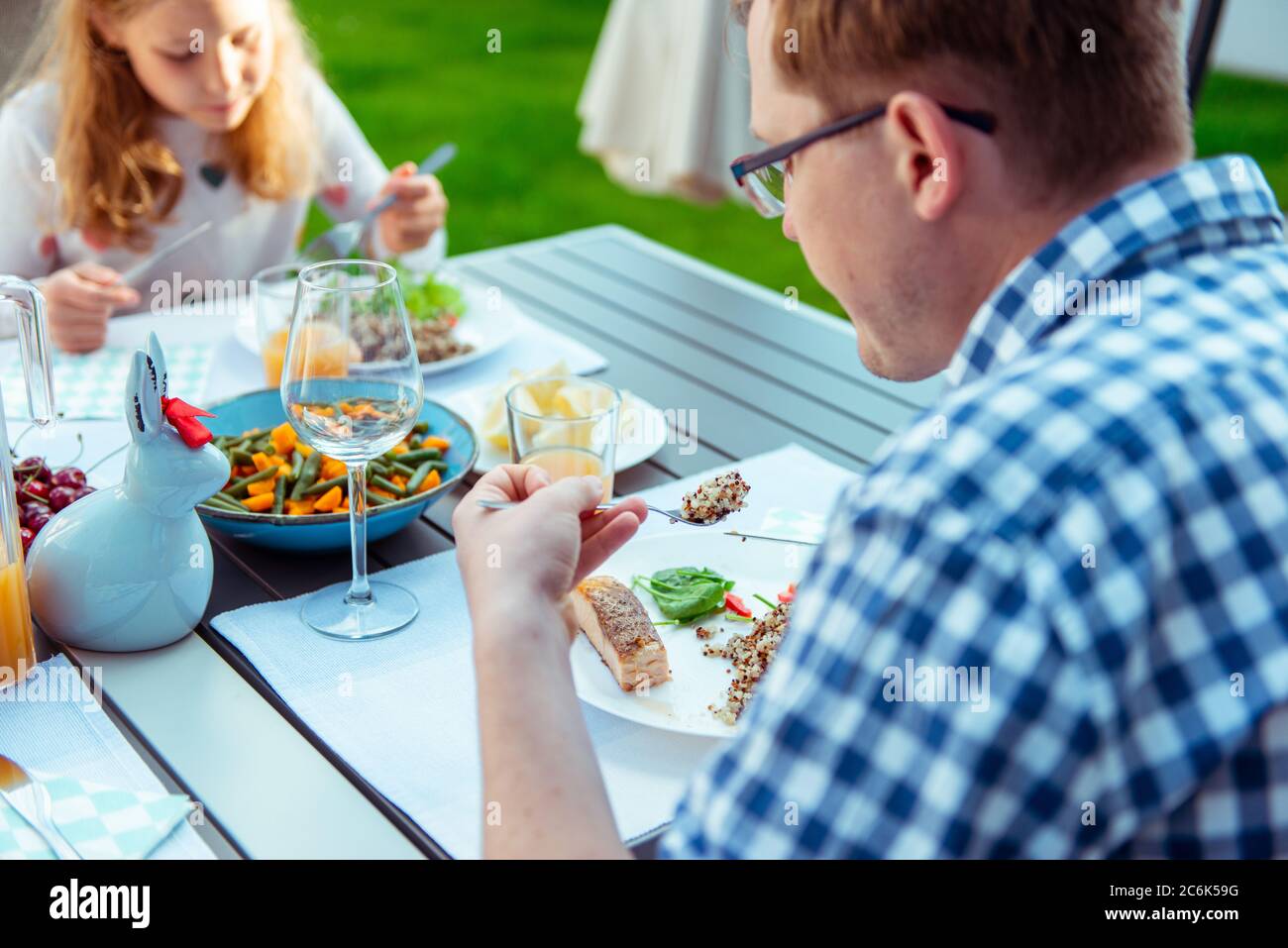 Happy family eating healthy dinner together on terrace at home Stock ...
