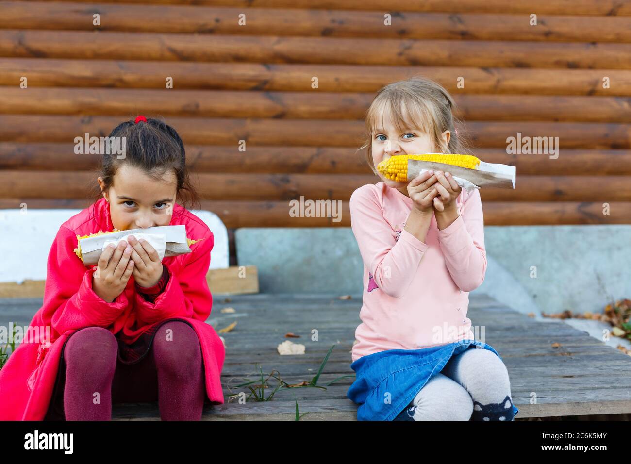 little girls eating messy corn on the cob Stock Photo - Alamy