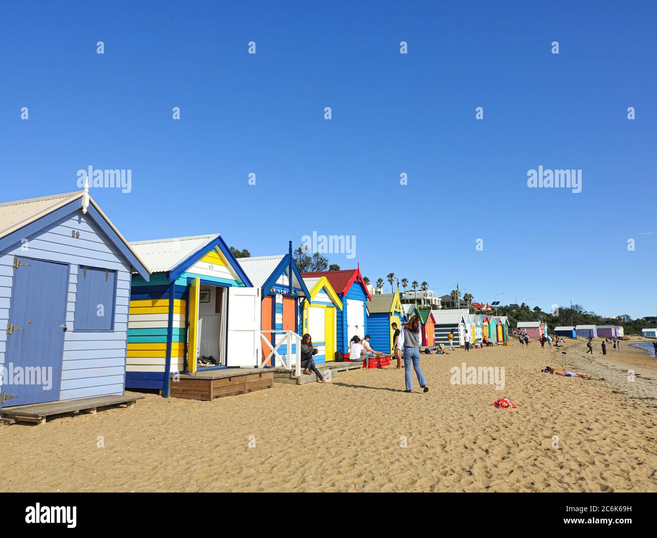 Colourful bathing boxes at Brighton Beach with tourism on vacation ...