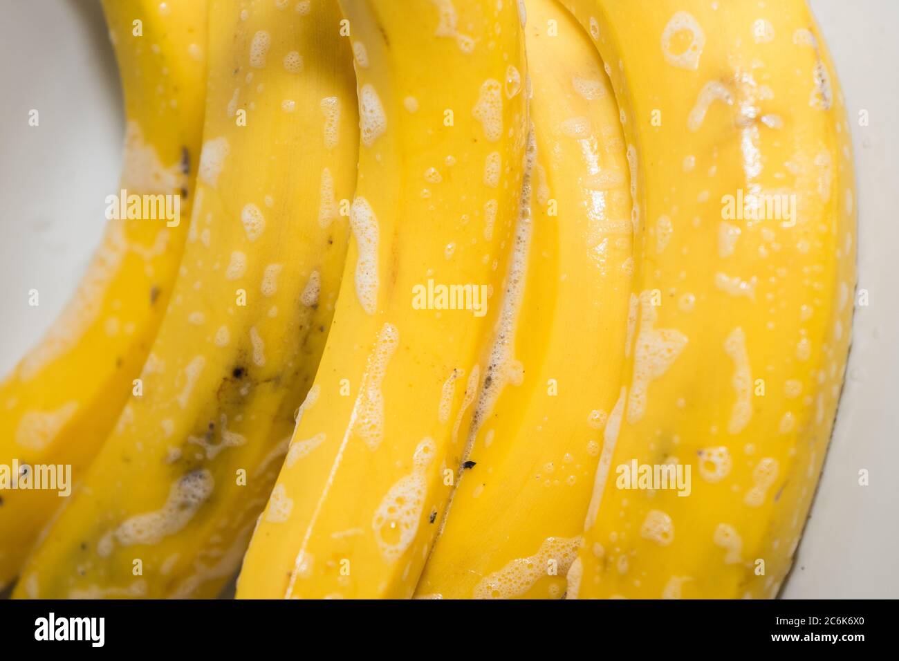 Soapy clean bananas in the sink. Washing fruit after purchase. virus ...