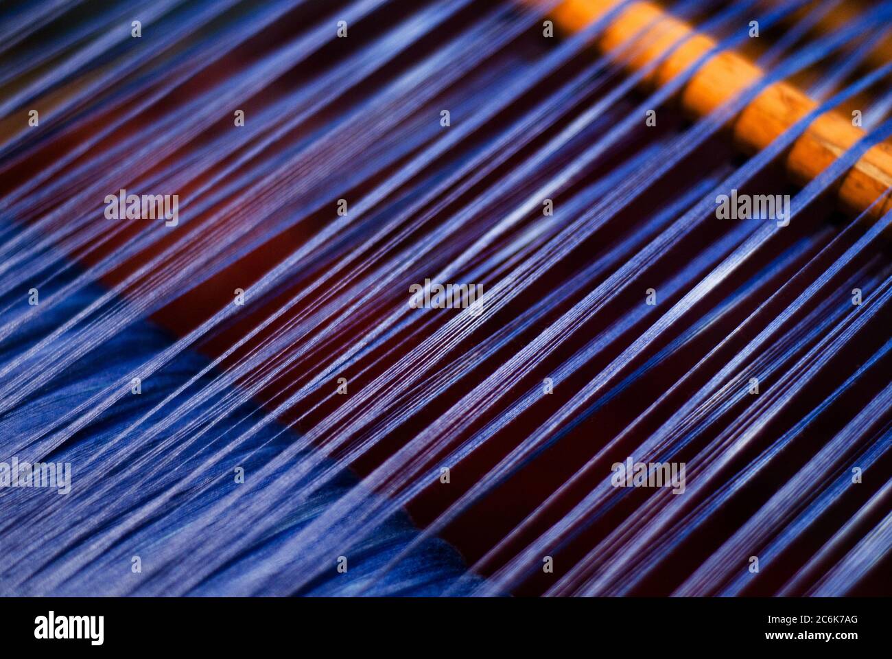 Detail of blue thread being woven at a loom Stock Photo - Alamy