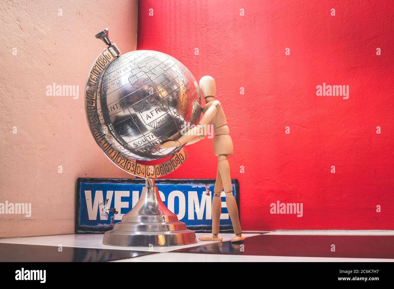 Wooden Human Manikin posing with an ornamental silver world globe Stock ...