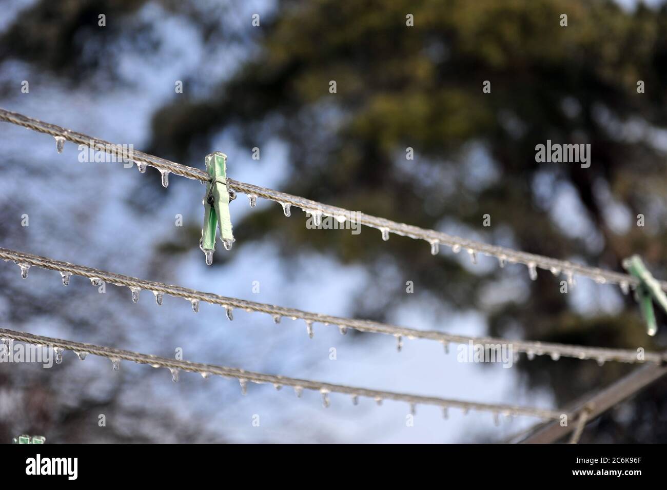 Frozen clothes peg on clothesline. Horizontal photo with copy space ...