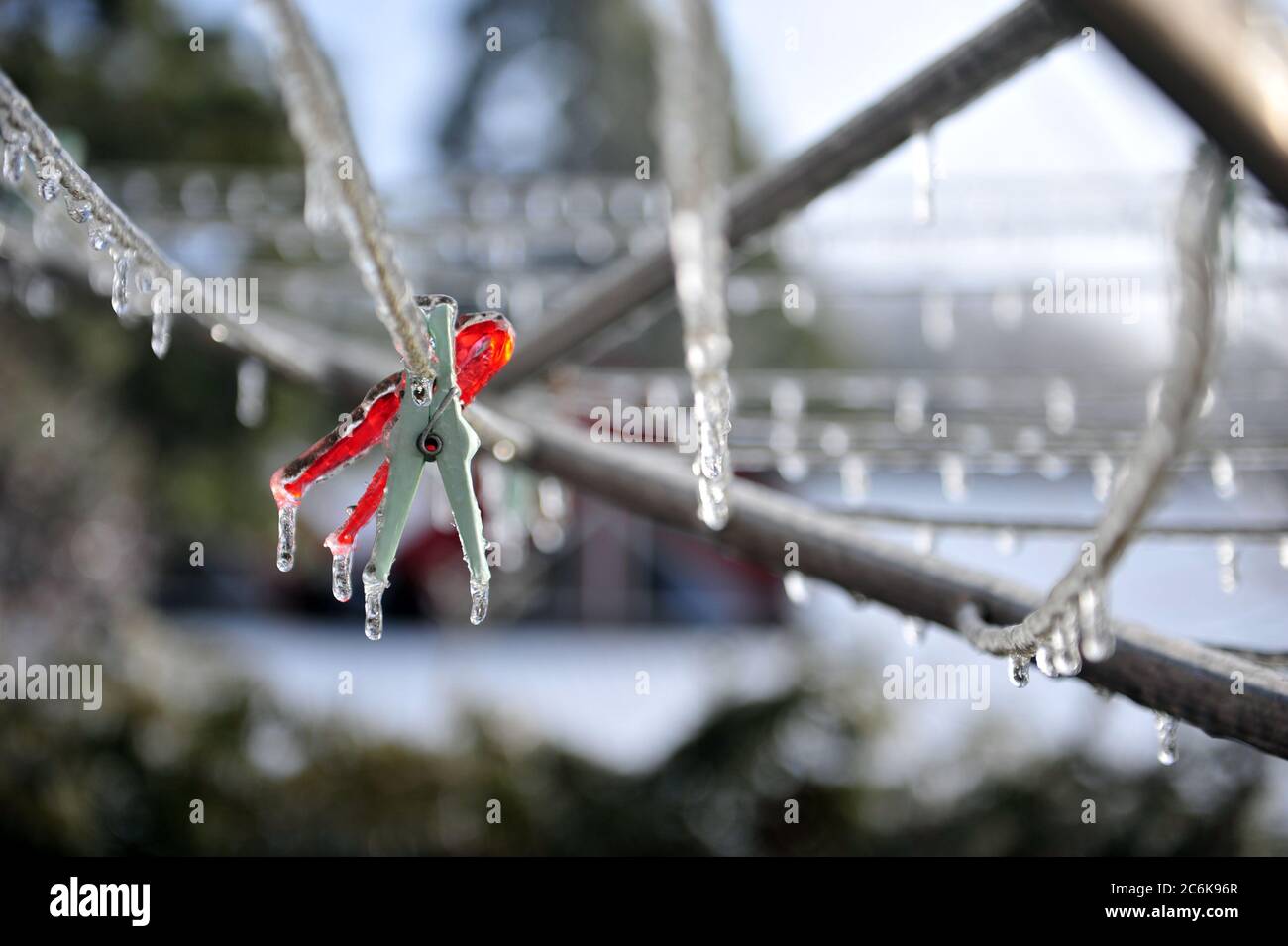 Ice covered clothes pegs on clothesline. Horizontal shot with soft ...