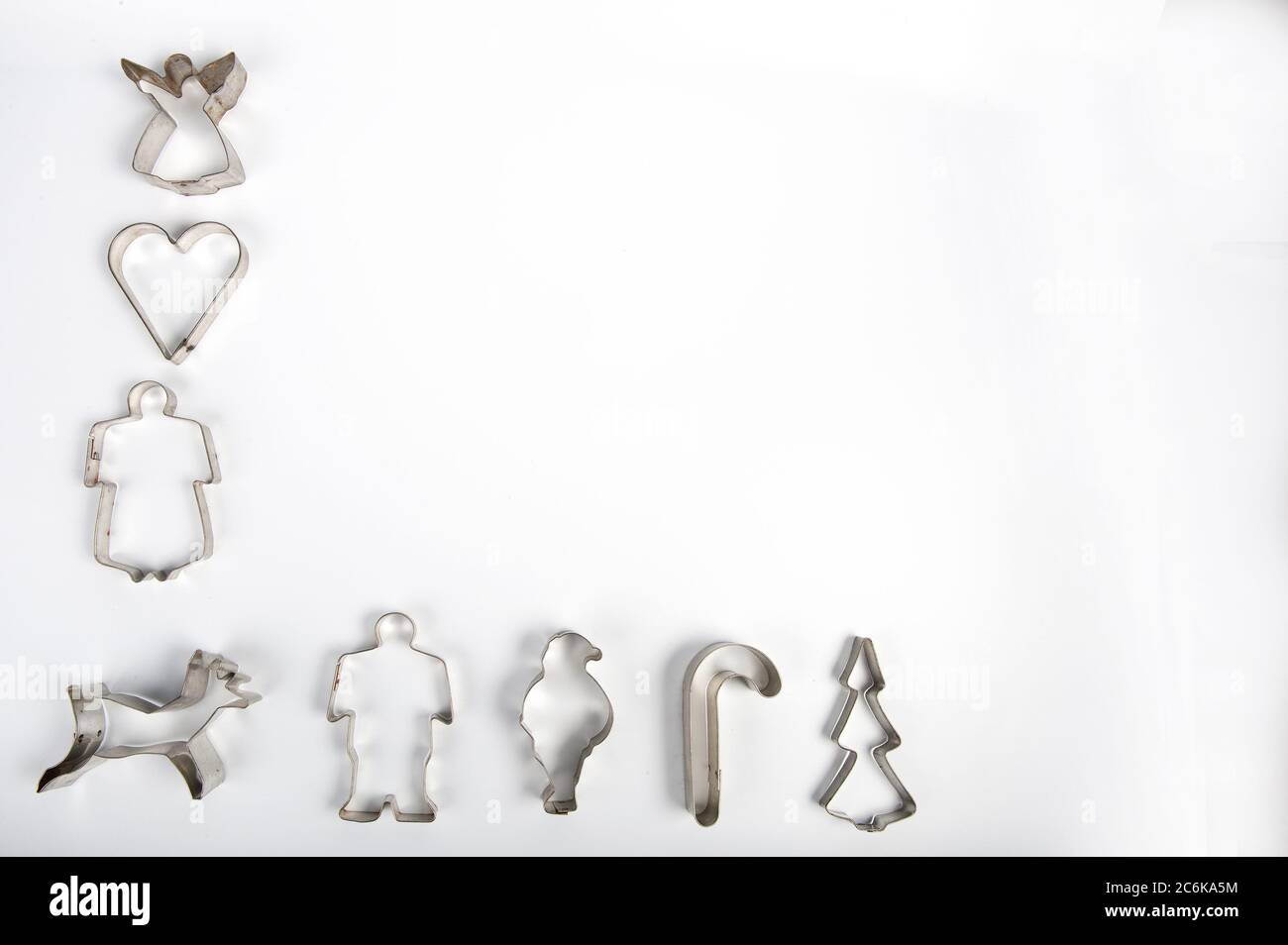 Christmas border of cookie cutters on white surface. Copy space in the ...