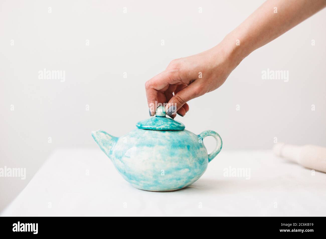 Close up photo of handmade blue teapot at pottery studio isolated Stock ...