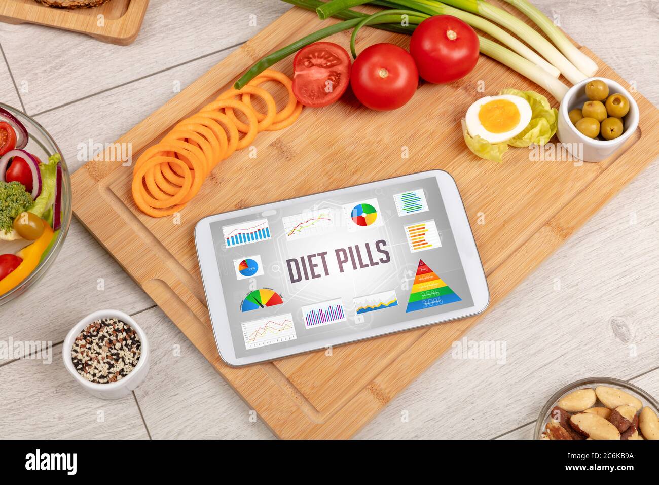Organic food and tablet pc showing DIET PILLS inscription, healthy ...