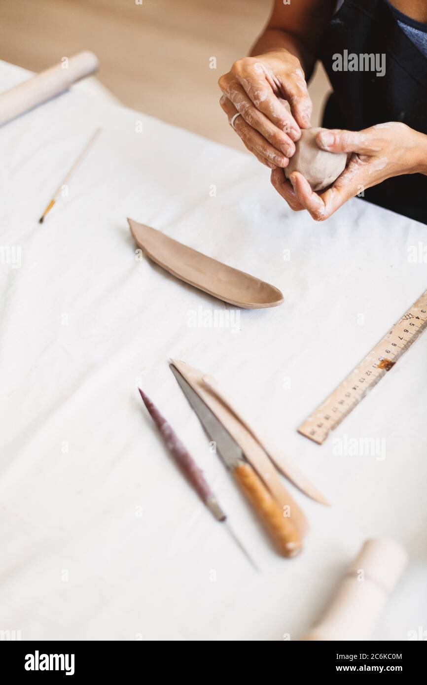 Close up woman hands working with clay at pottery studio Stock Photo ...