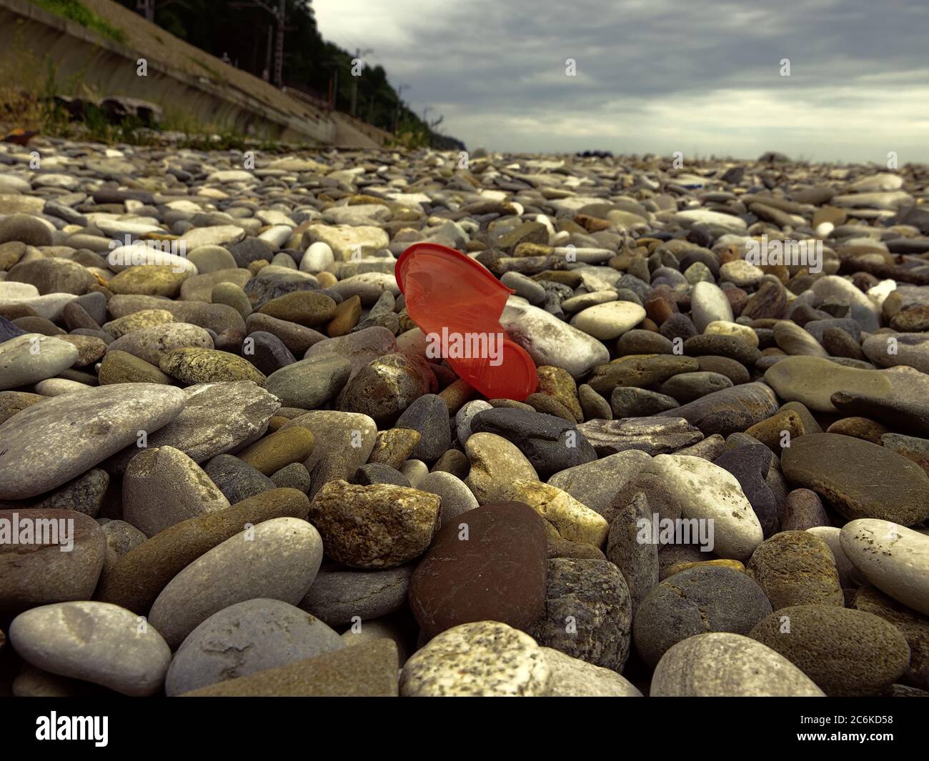 Against plastic clogging of the earth. Plastic Cup crumpled and thrown ...
