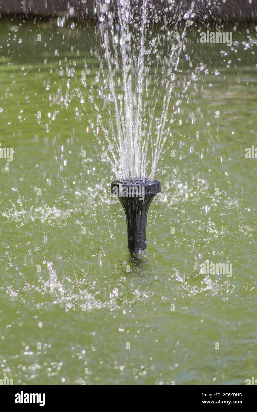 Small fountain on green background hi-res stock photography and images ...