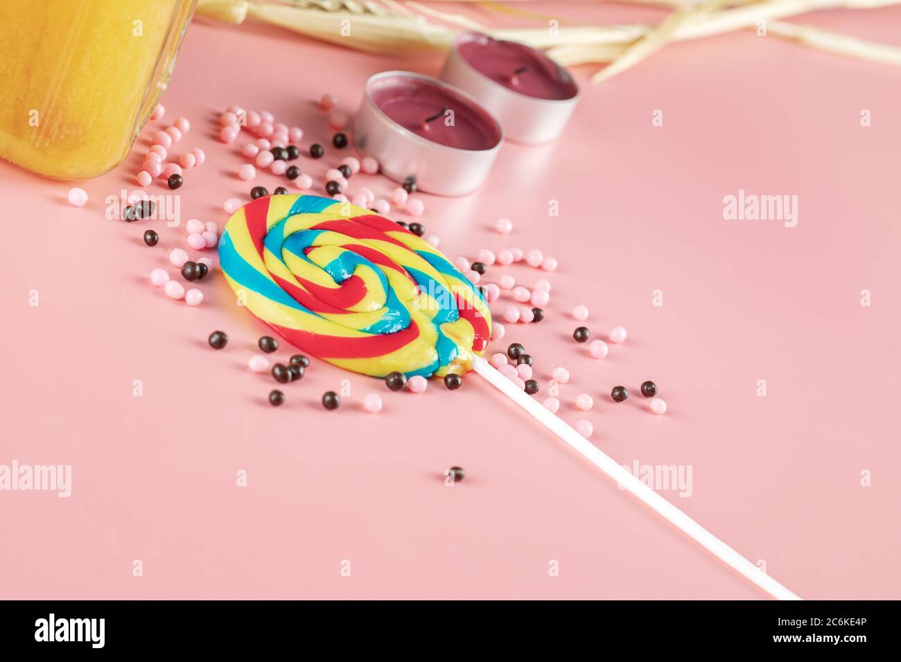 Rainbow popsicle with pink pearl candies around Stock Photo - Alamy
