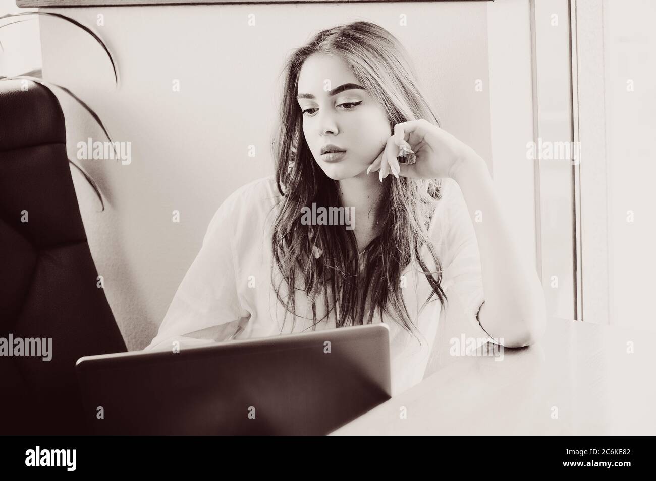 Photo of affable woman with long brown hair holding silver personal ...