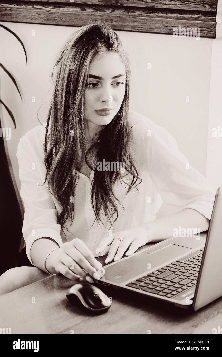 Photo of affable woman with long brown hair holding silver personal ...