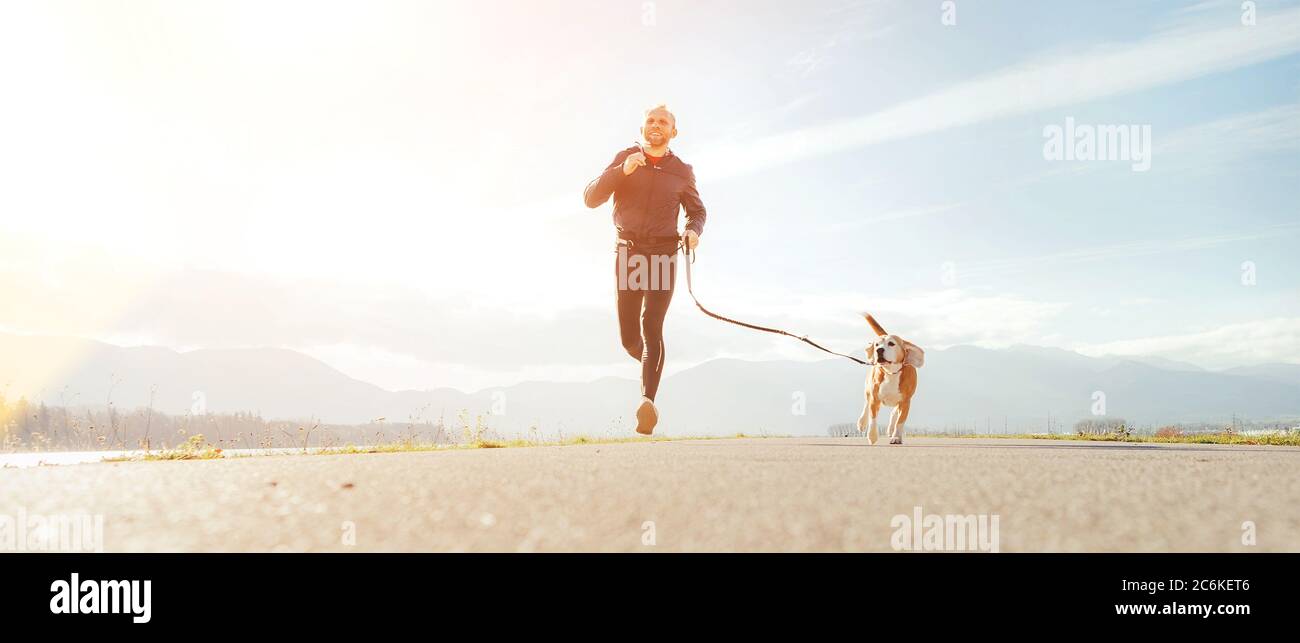 Jogging man with his dog in the morning. Active healthy lifestyle ...
