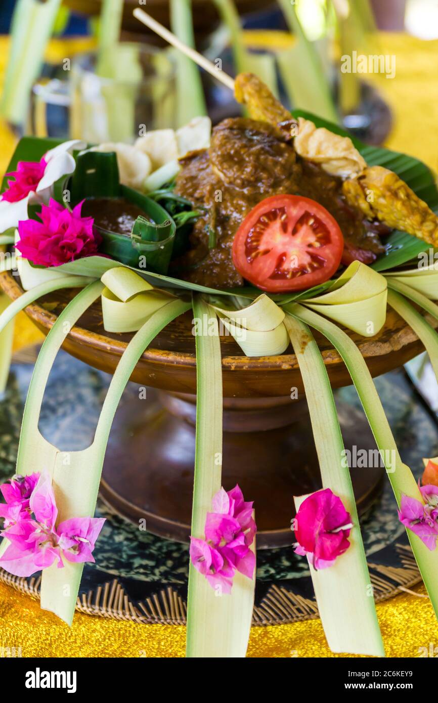 Typical balinese food with meat, kebab ,tomatoes and other vegetables ...