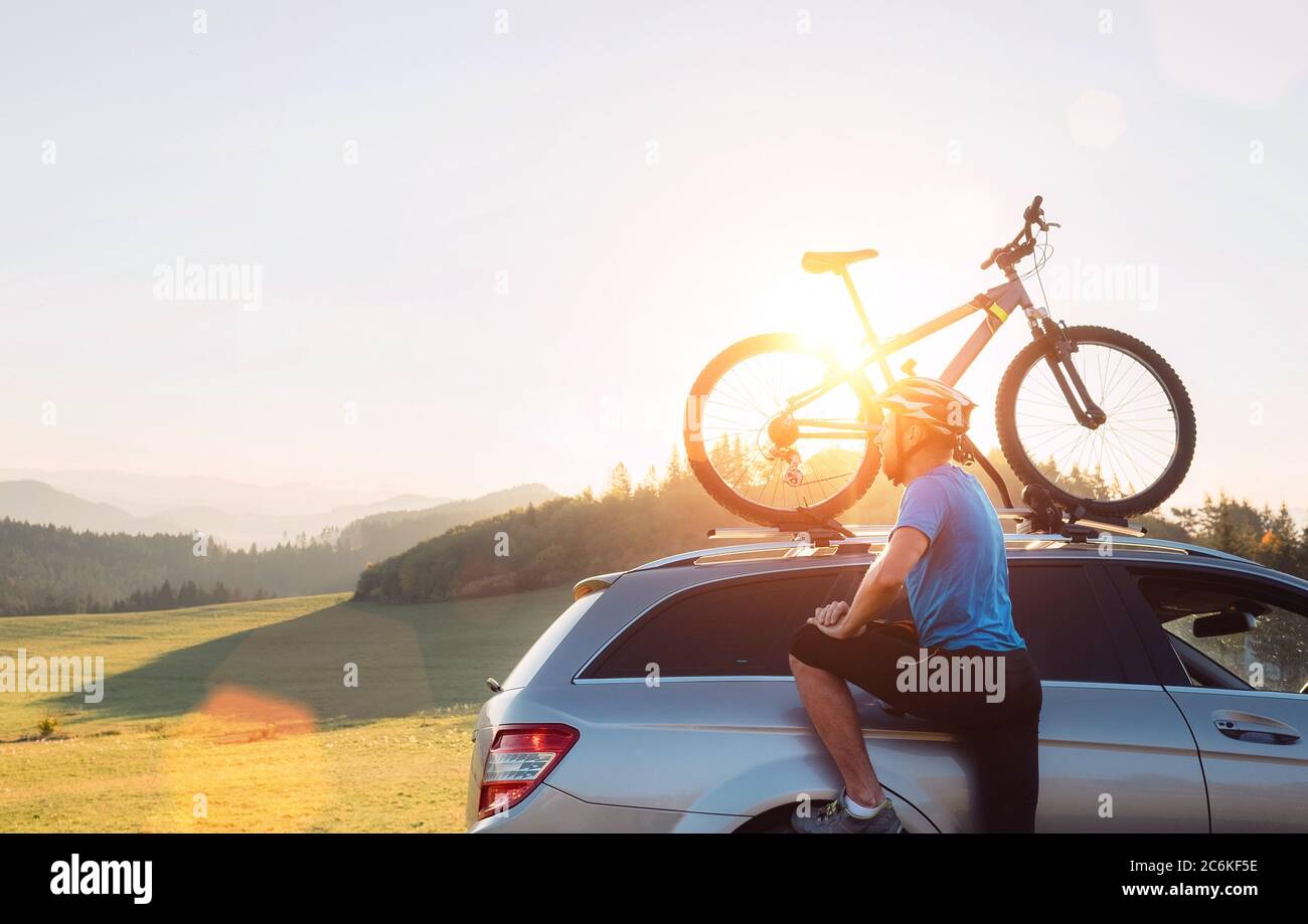 Man take his bicycle from car roof. Mountain biking concept Stock Photo ...