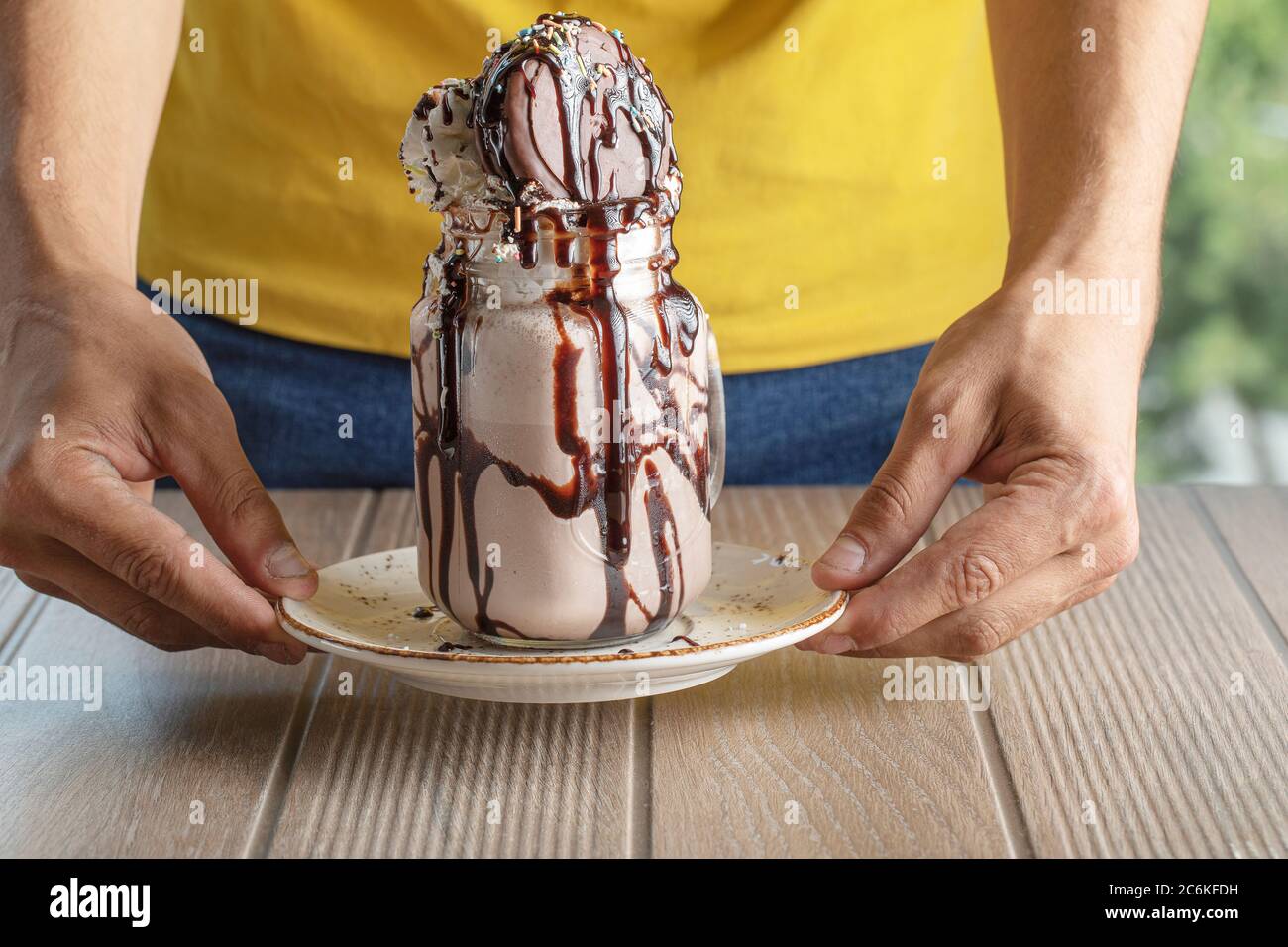 Creamy vanilla milky shake with chocolate sauce in a white saucer Stock ...