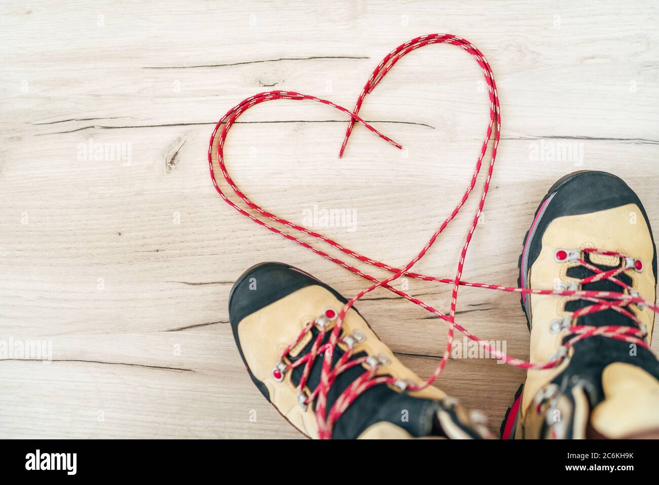 Conceptual image of the pair new trekking boots on the wooden floor ...