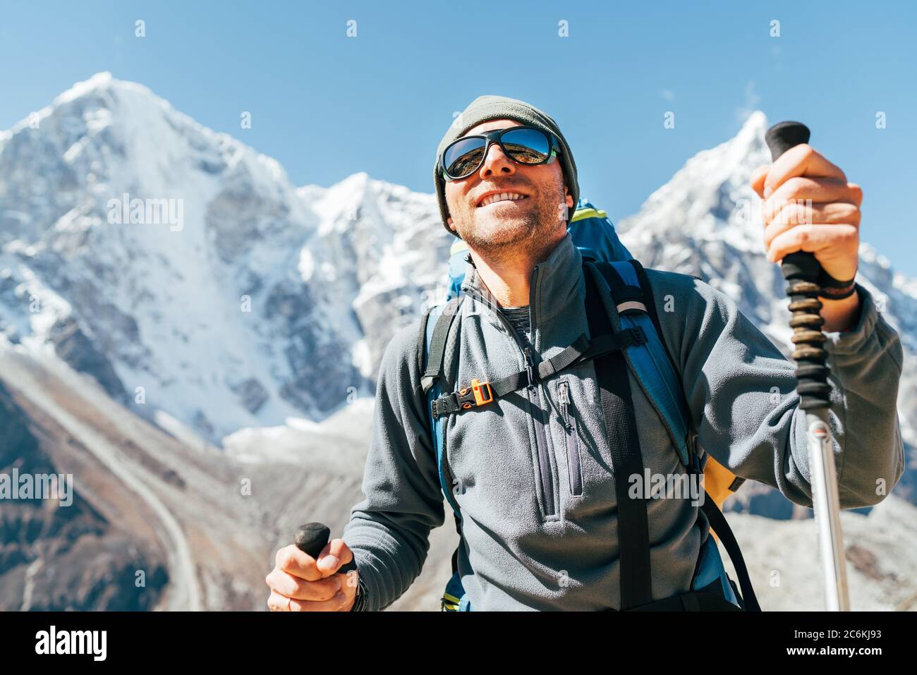 Portrait of smiling Hiker man on Taboche 6495m and Cholatse 6440m peaks ...