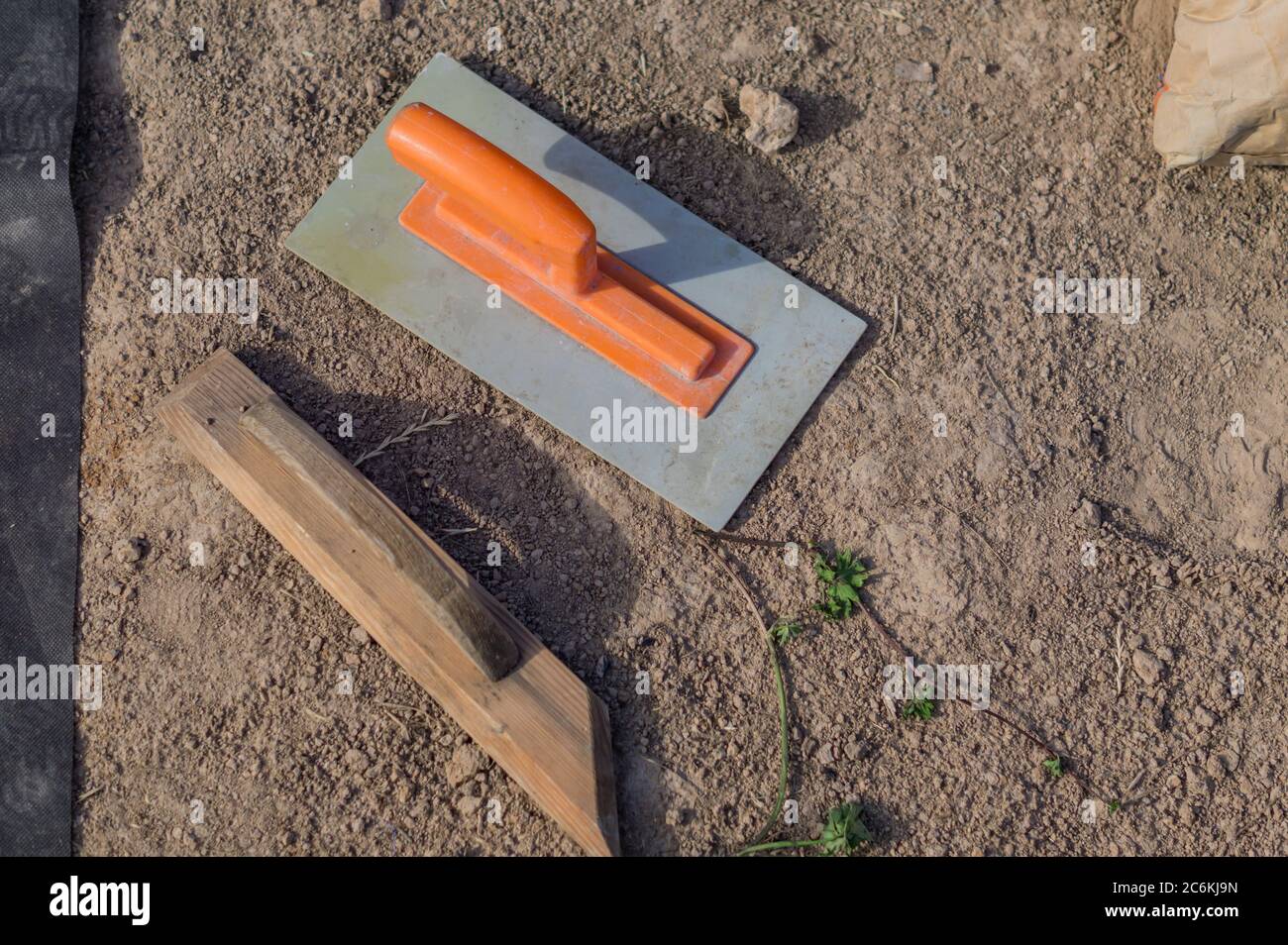 wooden and metal screed for concrete on the ground Stock Photo - Alamy
