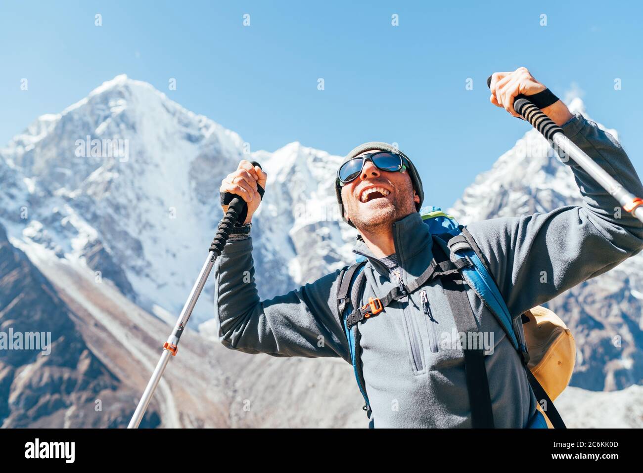 Portrait of smiling Hiker man on Taboche 6495m and Cholatse 6440m peaks ...