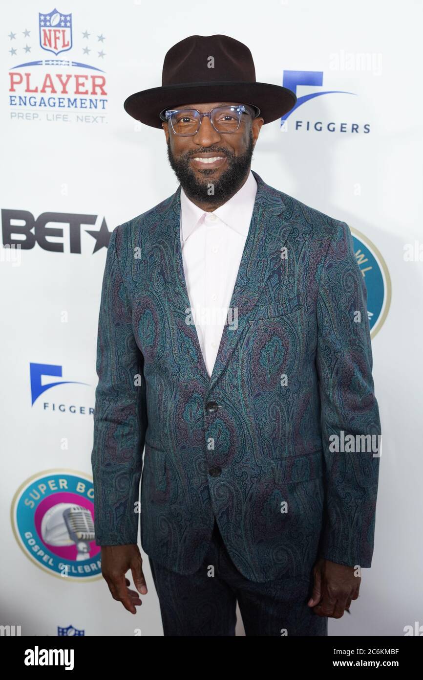 Rickey Smiley pose for pictures during the 21st Annual Super bowl ...