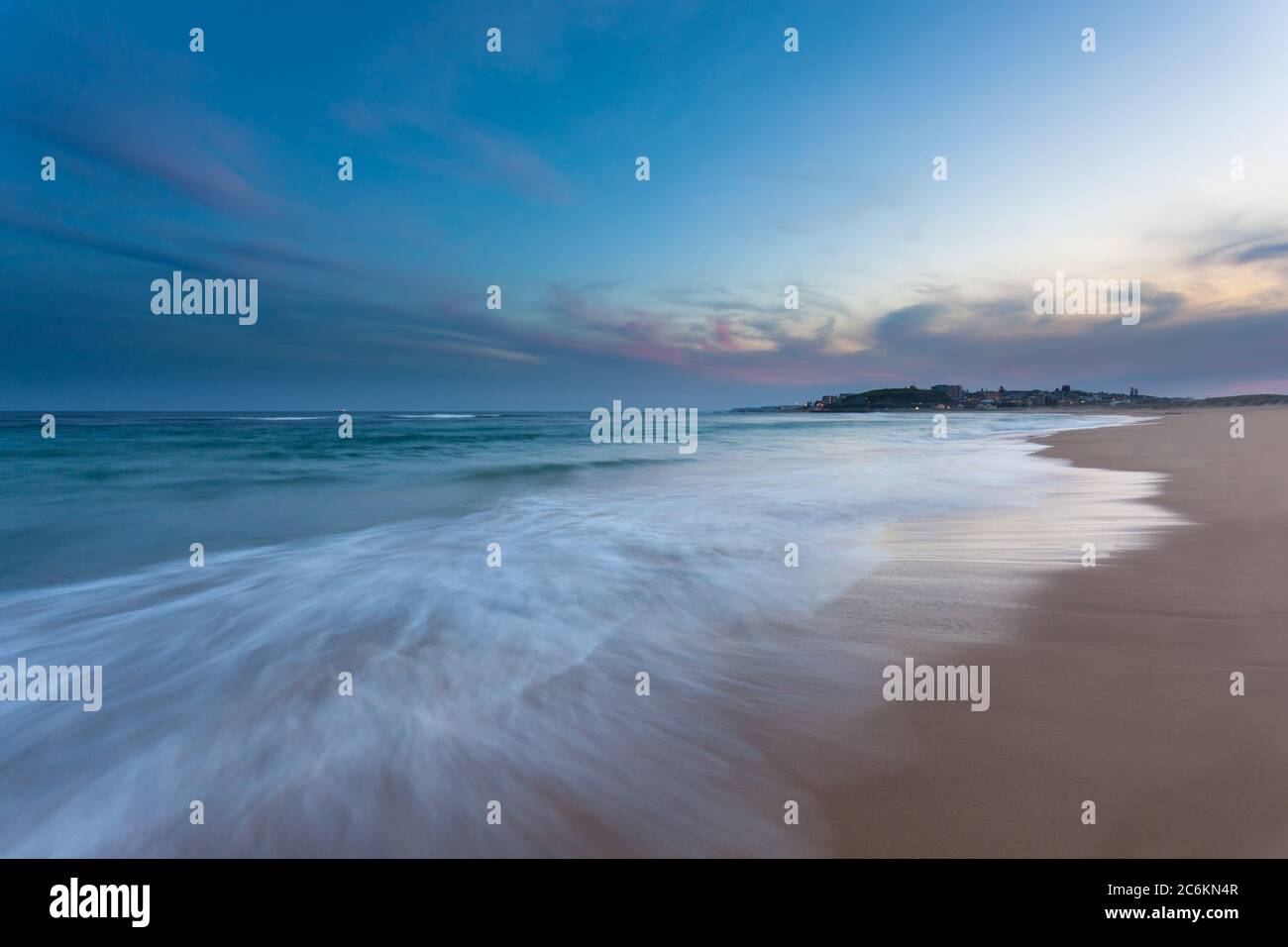 Nobbys Beach at twilight with flowing waves. Nobbys Beach is one of ...
