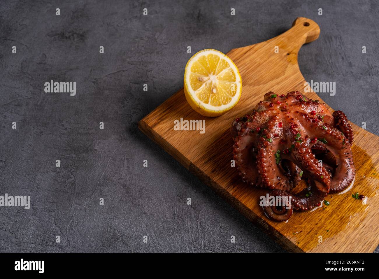 Grilled whole octopus on a cutting Board. Gray background. Top view ...