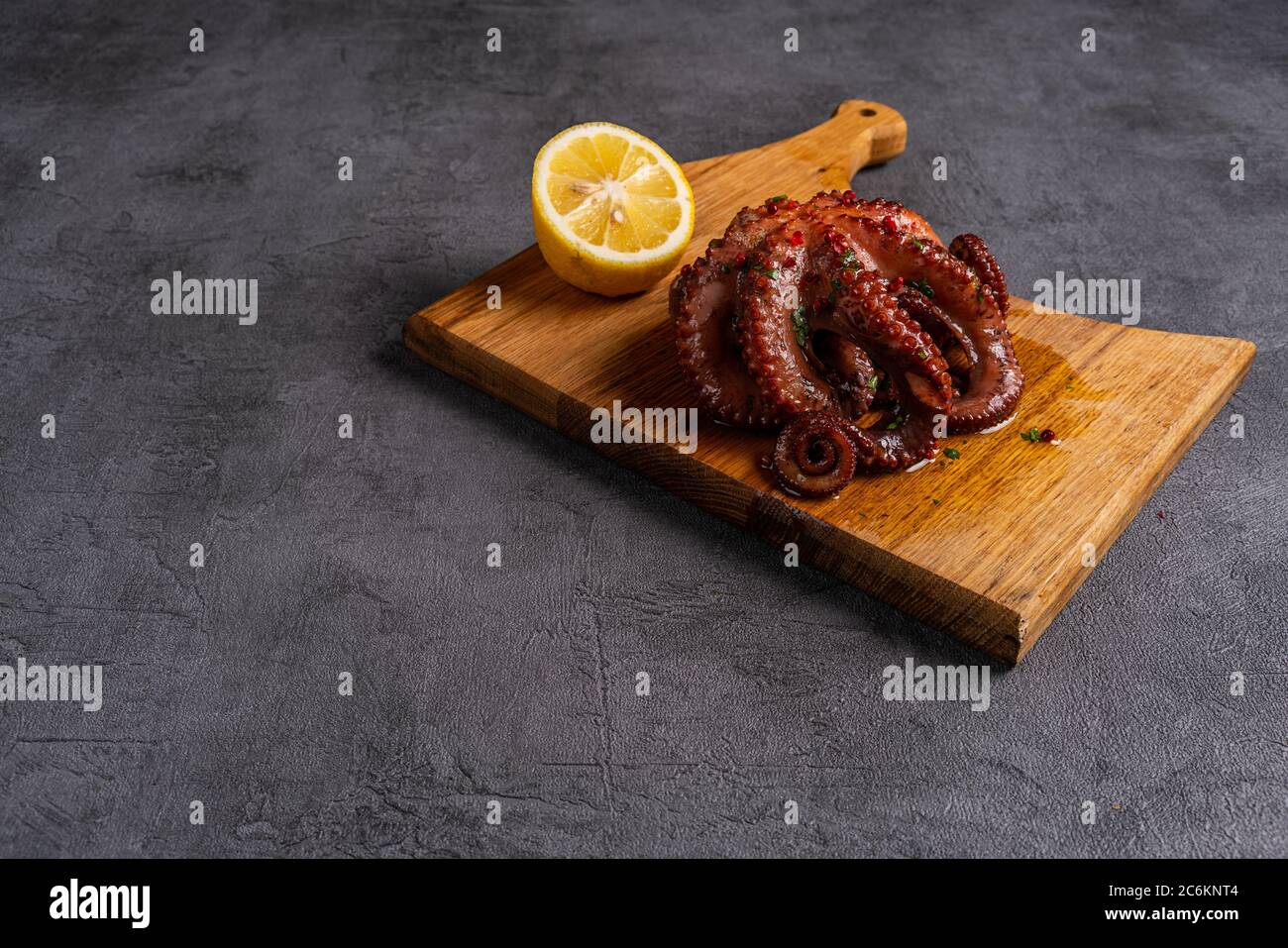 Grilled whole octopus on a cutting Board. Gray background. Top view ...