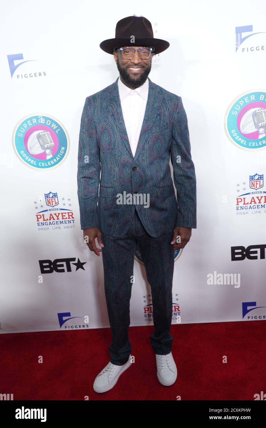 Rickey Smiley pose for pictures during the 21st Annual Super bowl ...