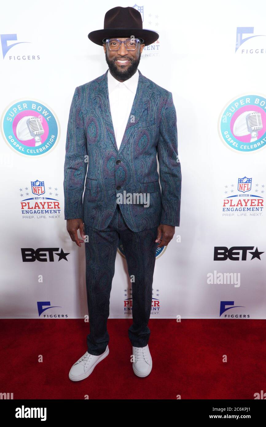 Rickey Smiley pose for pictures during the 21st Annual Super bowl ...