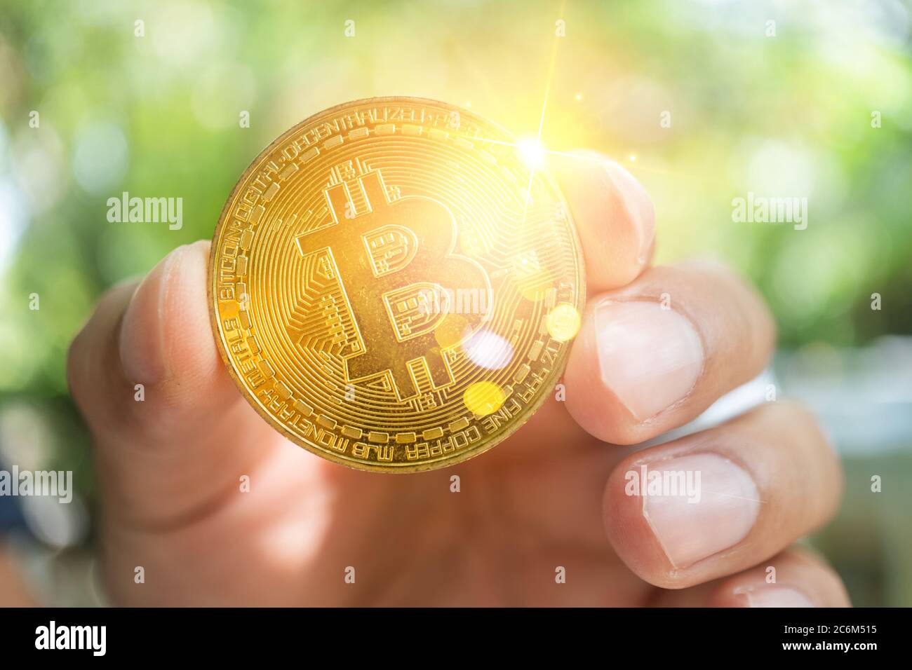 Hand hold a symbol of Bitcoins as digital money cryptocurrency with ...