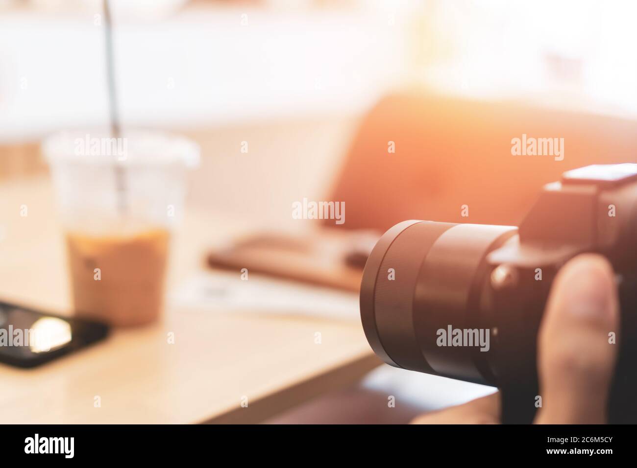 Selective focus of DSLR camera shooting object in cafe background Stock ...
