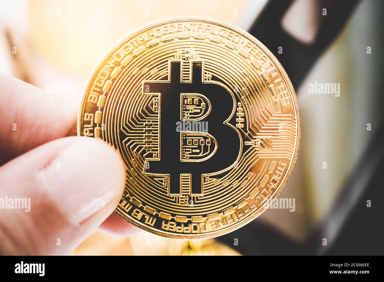 Hand hold a symbol of Bitcoins as digital money cryptocurrency ...