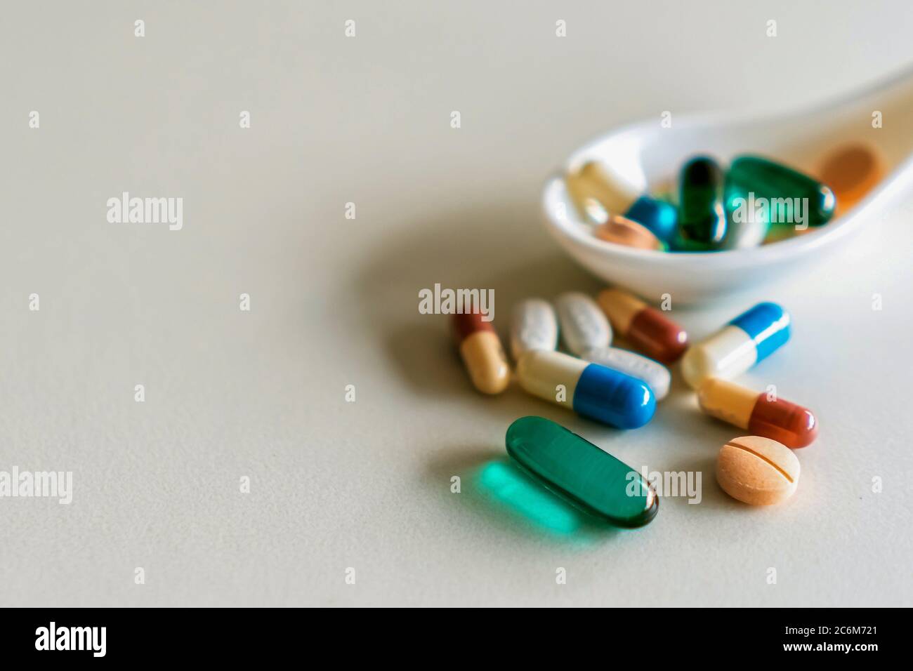 Mixed of pill or tablet medicine on white spoon on white background ...