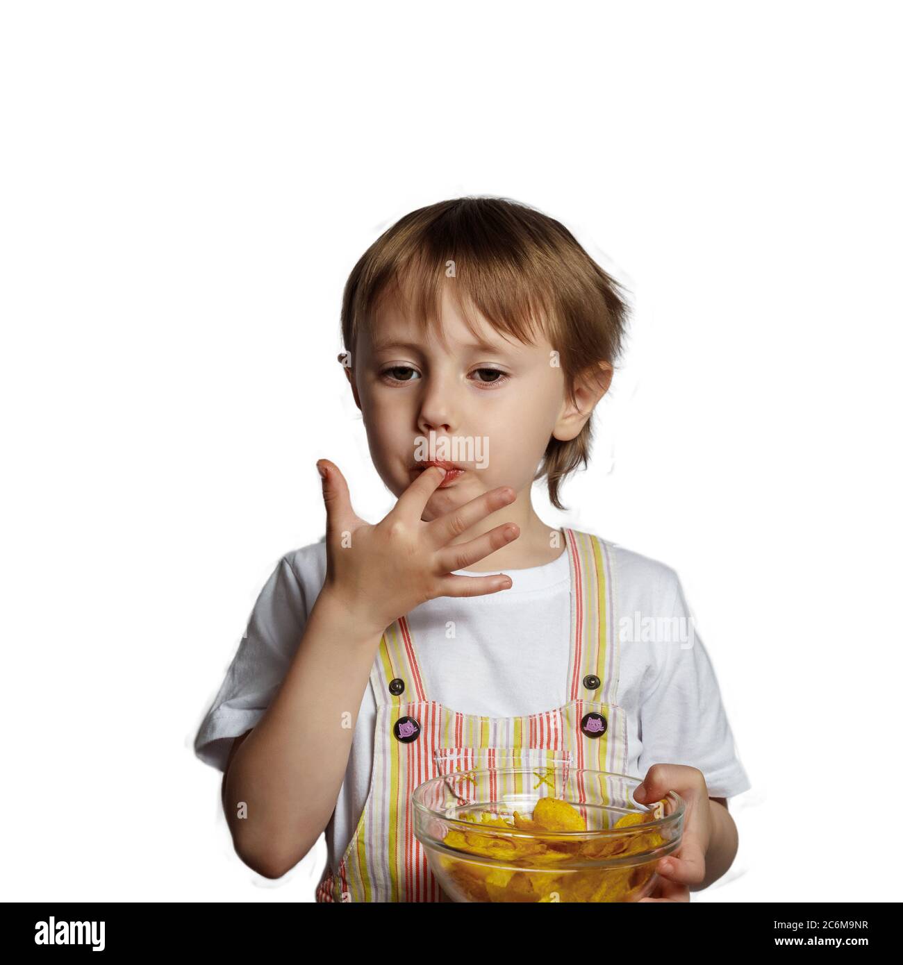Cute little girl eating chips with potato chips in plate on white ...