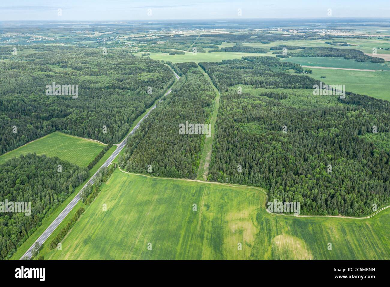 Aerial view of road through agricultural fields and forest hi-res stock ...