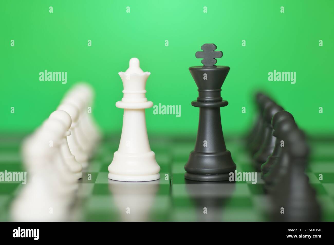Chess game and green background. Conceptual scene Stock Photo - Alamy