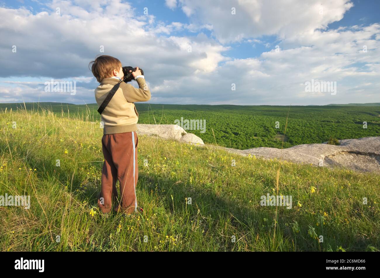 Kid take a photography. Child photographs nature in mountain Stock ...