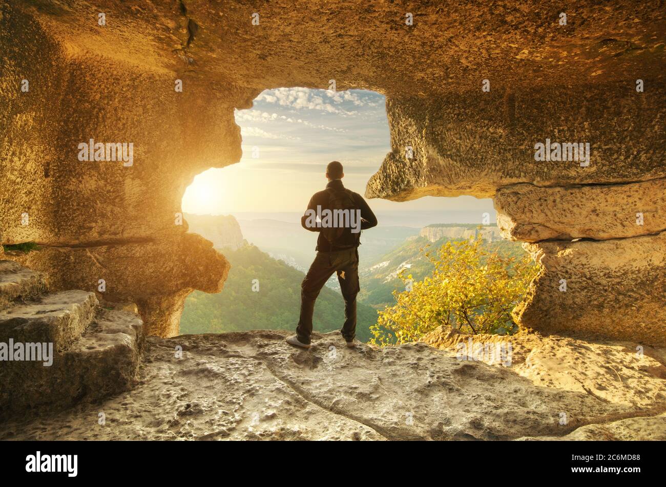 Man in cave mountain. Conceptual scene Stock Photo - Alamy