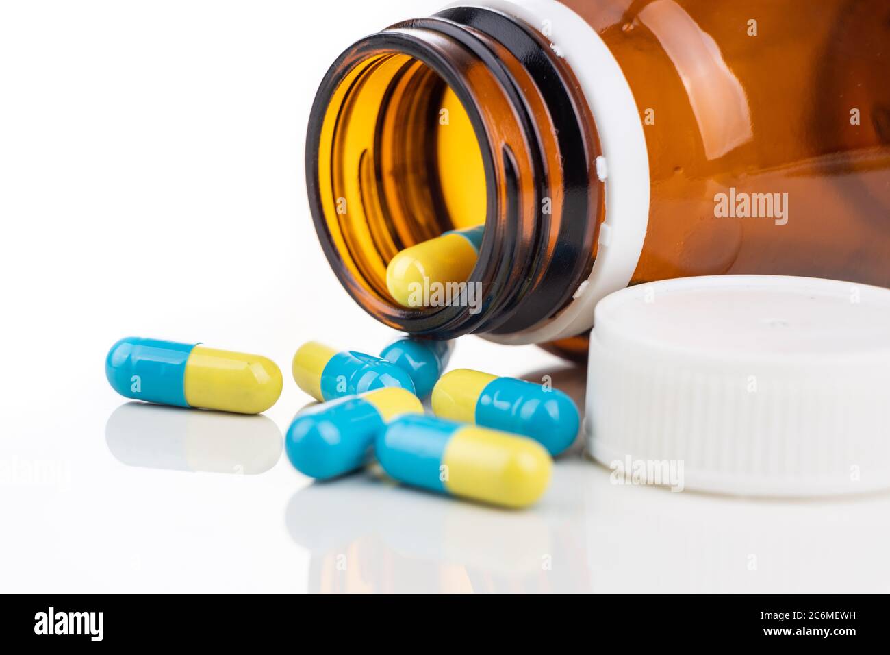 Close-up medicine drug in capsule format with bottle on white ...