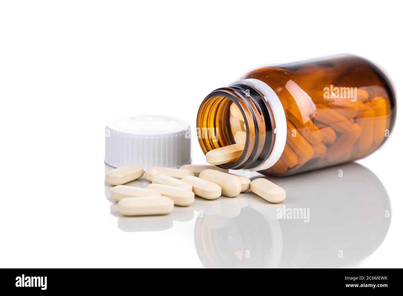 Supplement or medicine in caplet format with opaque glass bottle on ...